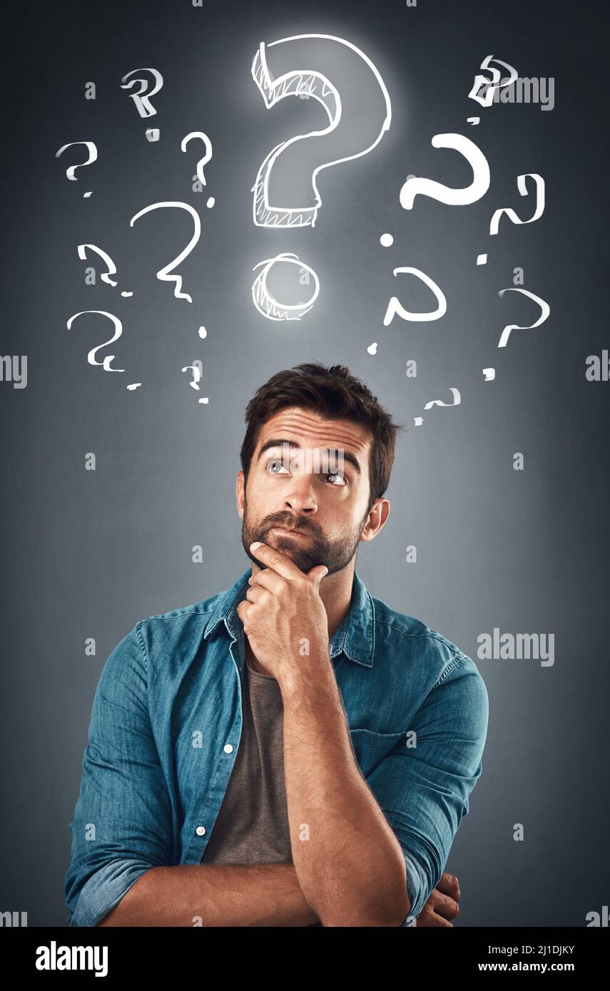 Hes full of bright ideas. Studio shot of a handsome young man looking ...