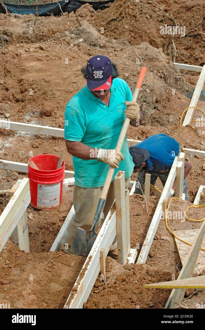 Putting in Cement footings for walls of new house by latin labour ...