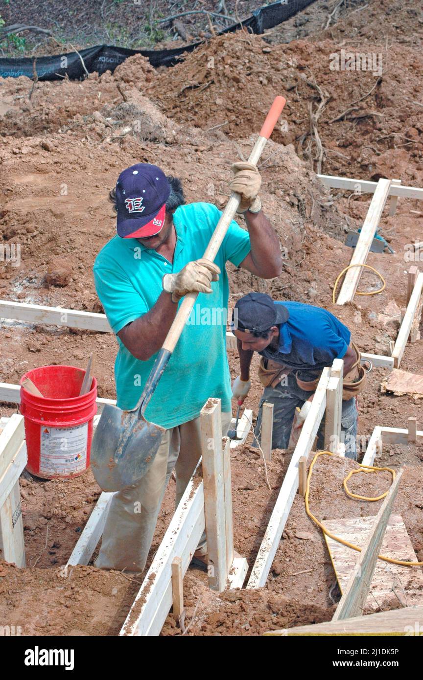 Putting in Cement footings for walls of new house by latin labour ...