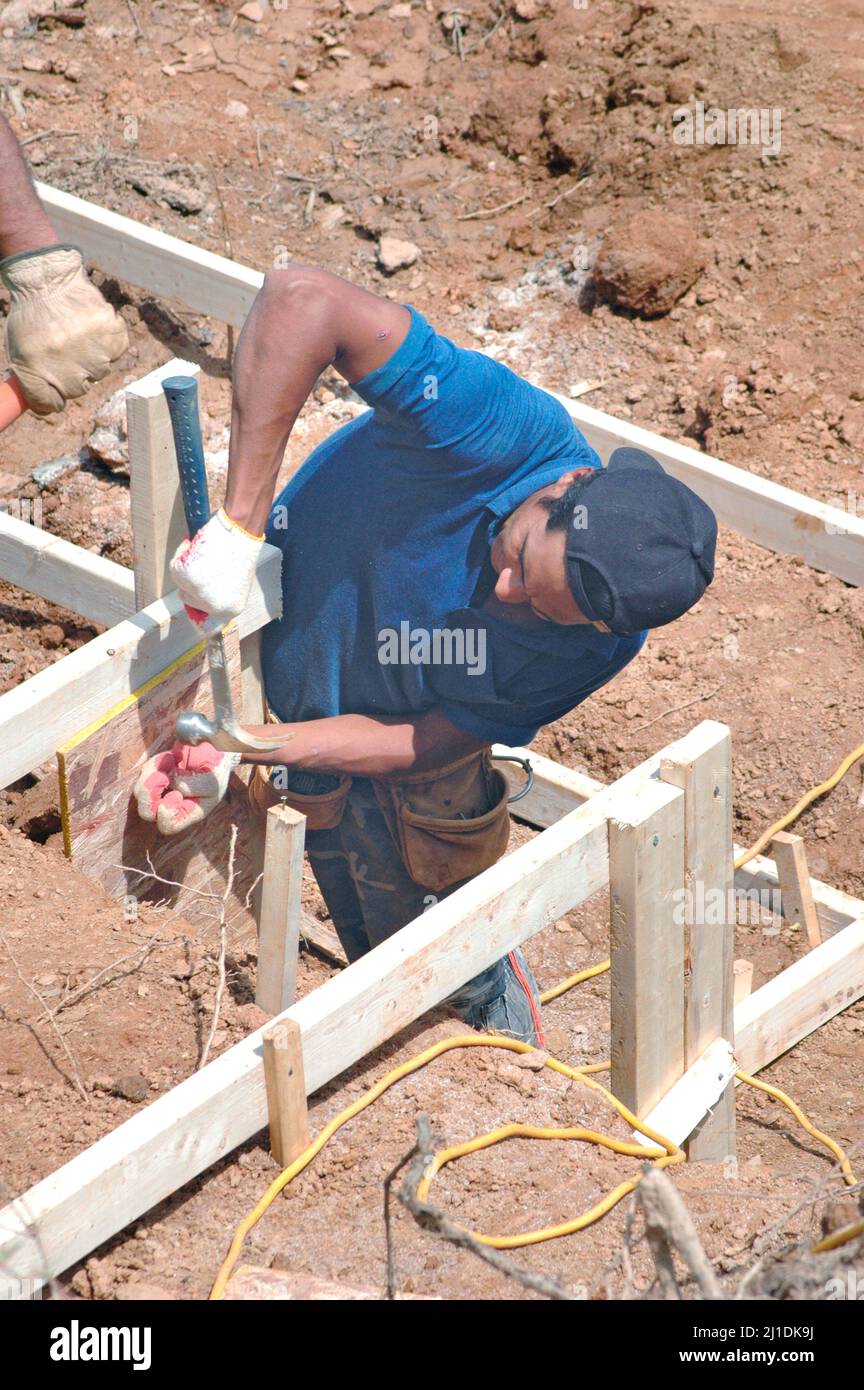 Putting in Cement footings for walls of new house by latin labour ...