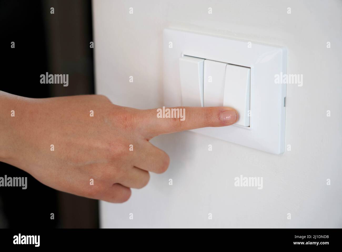 Energy saving. Female finger is turn off on lighting switch Stock Photo ...