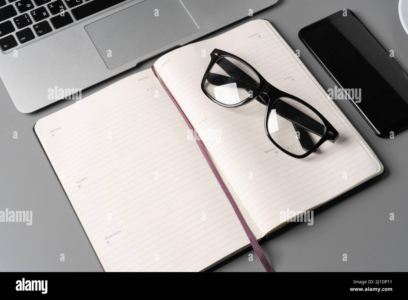 Notepad is on top of office desk table with laptop and supplies Stock ...