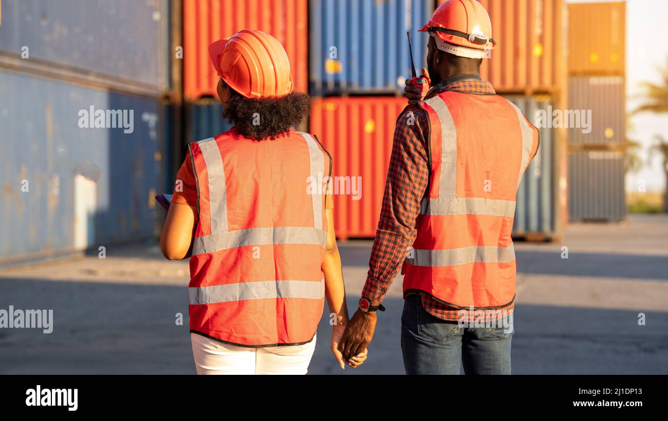 Couple love African at cargo container port Stock Photo - Alamy