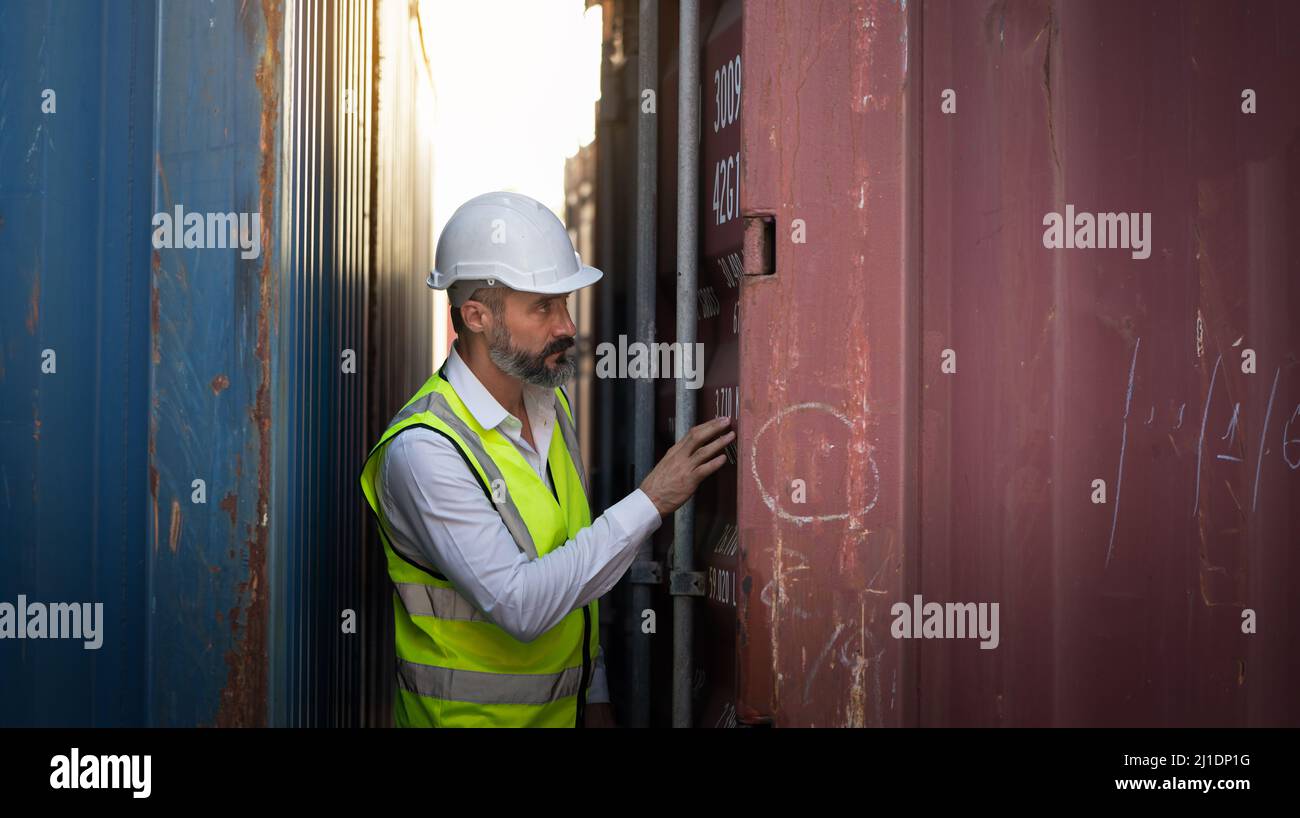 CEO or Manager in white helmet checking and control loading Containers ...