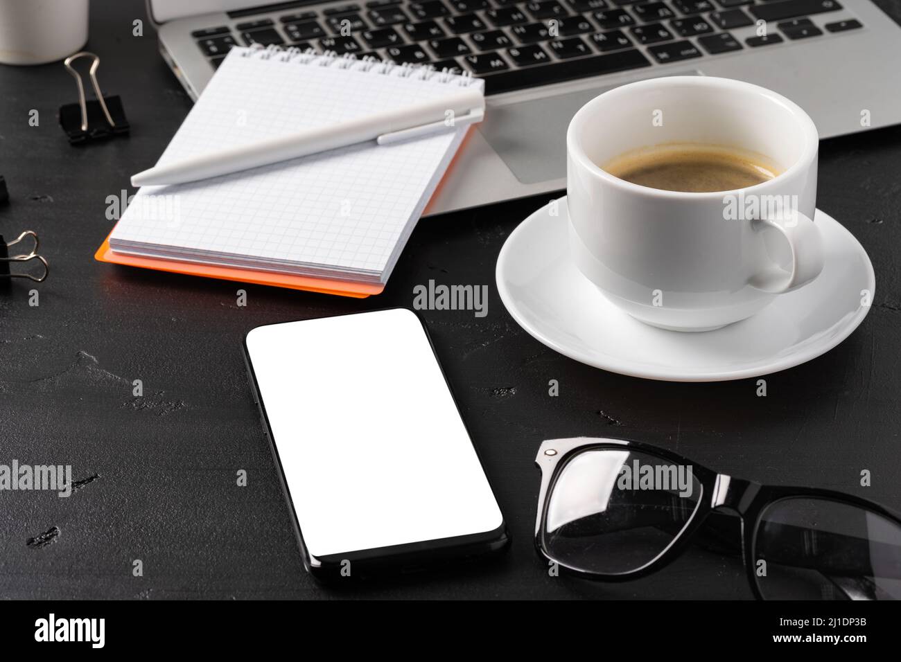 Notepad is on top of office desk table with laptop and supplies Stock ...