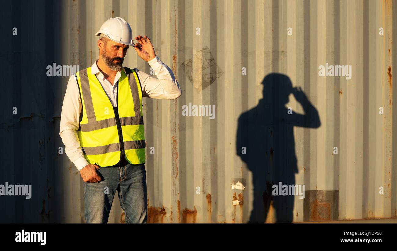 CEO or Manager in white helmet control loading Containers box in ...