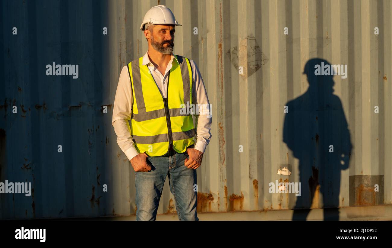 CEO or Manager in white helmet control loading Containers box in ...