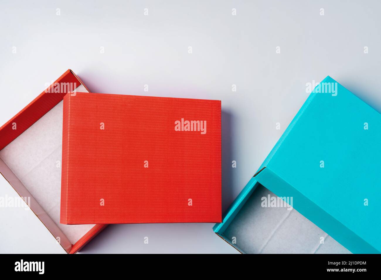 Pile of colorful cardboard boxes on white background Stock Photo - Alamy