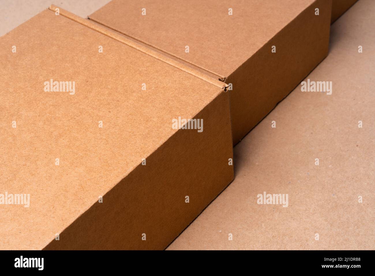 Cardboard box on beige background in studio Stock Photo - Alamy