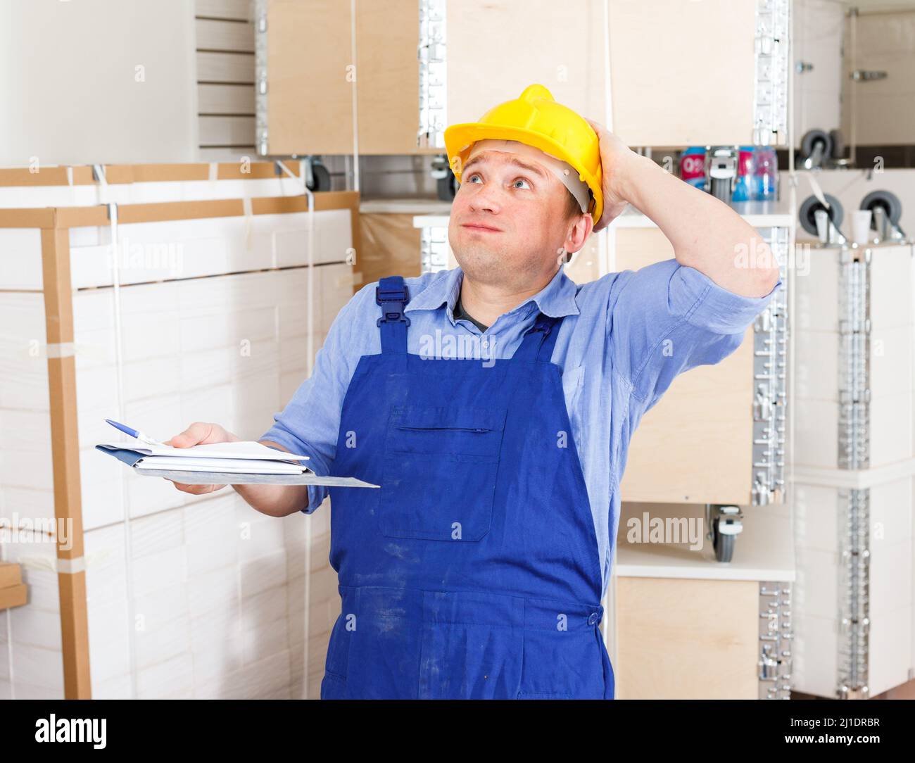 Confused male contractor Stock Photo - Alamy