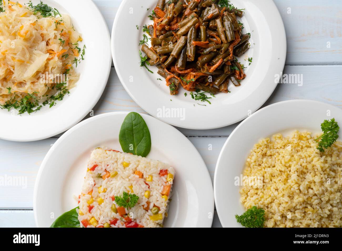 Variety of garnishes like cooked rice, bulgur, stewed cabbage and green ...