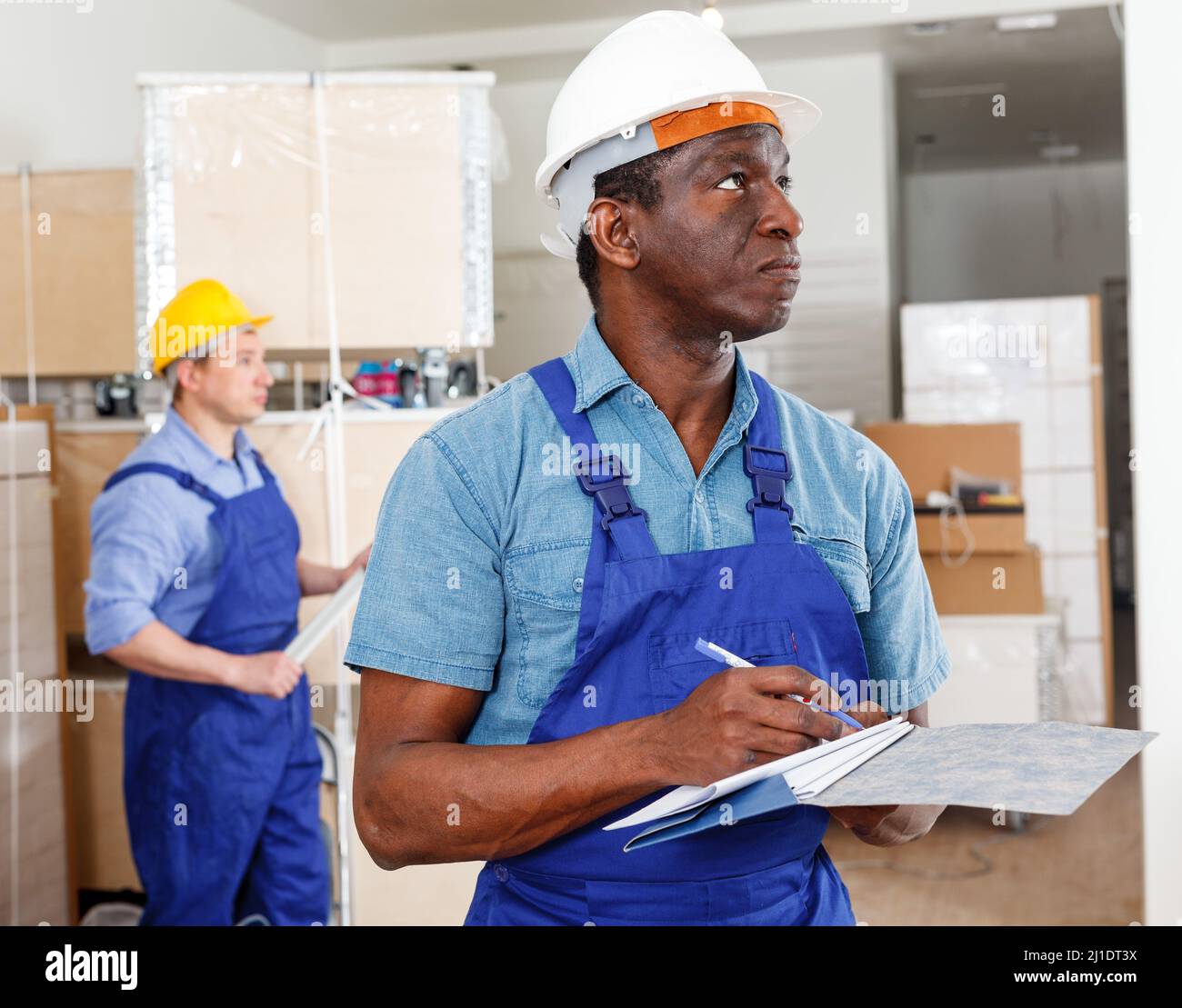 African-American contractor determining scope of building work Stock ...