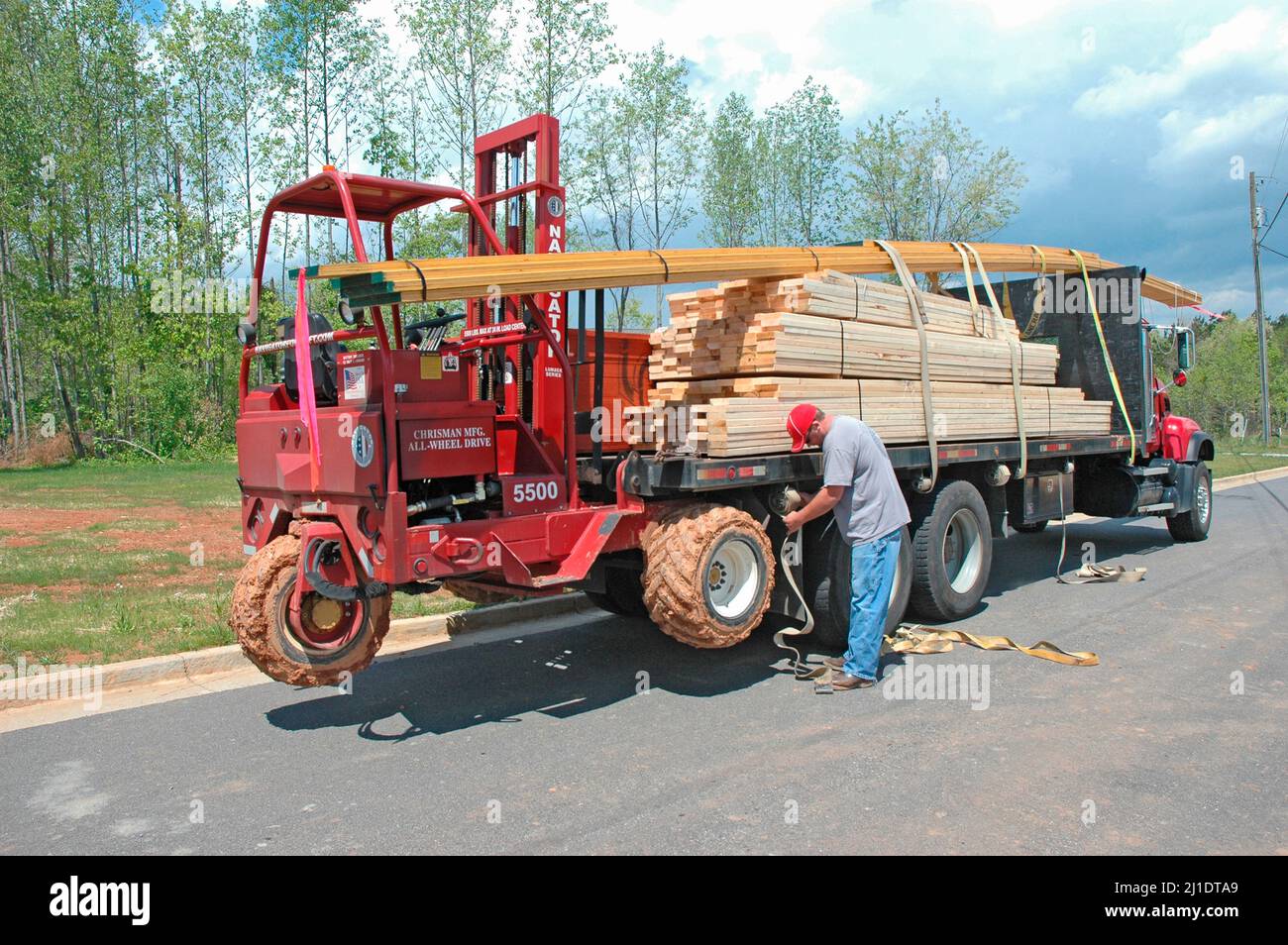 Delivering lumber by truck and fork lift the materials for wood framing ...