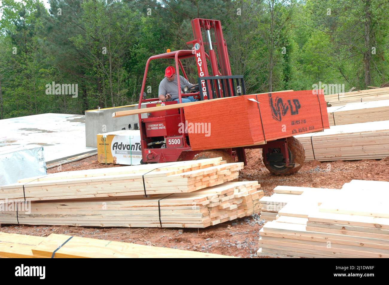 Delivering lumber by truck and fork lift the materials for wood framing ...