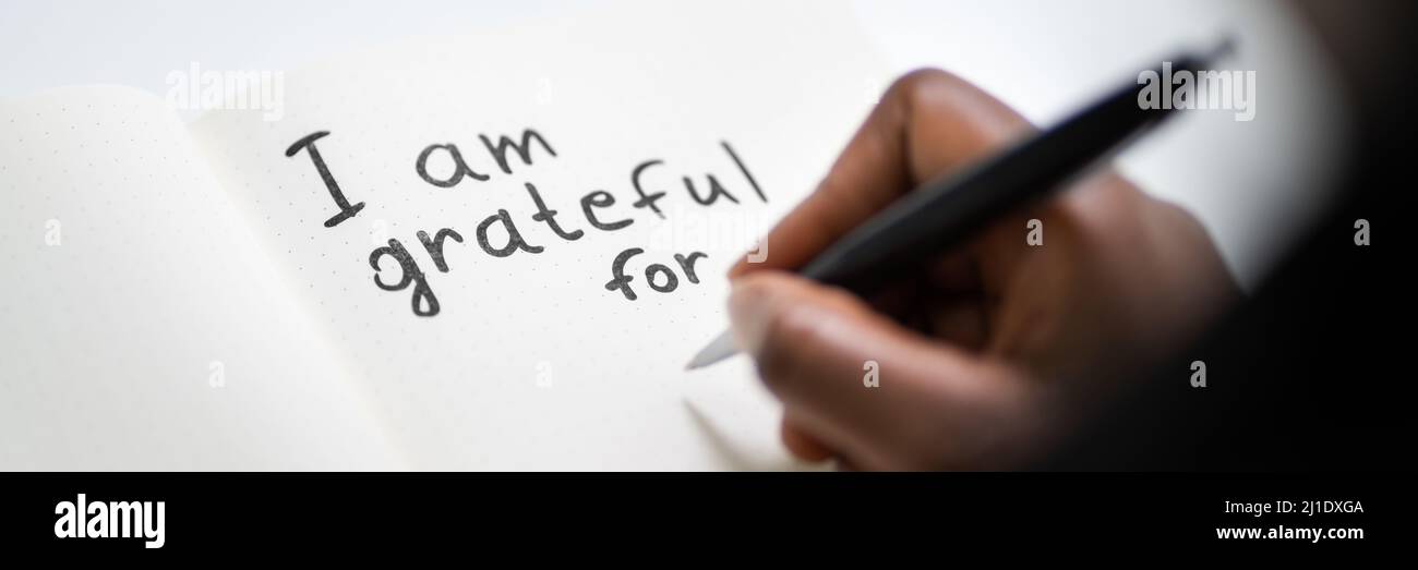 African American Women Writing In Gratitude Journal Stock Photo - Alamy