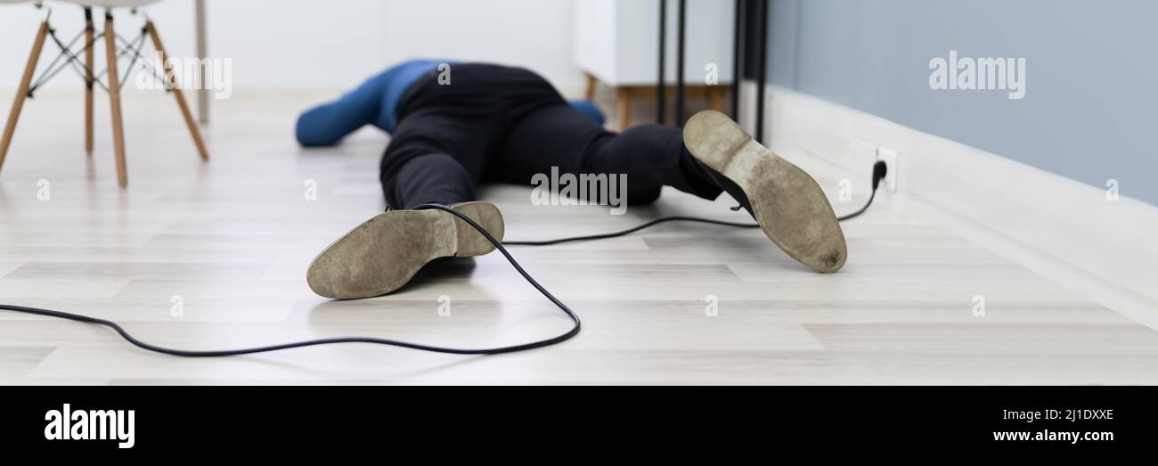 An Elevated View Of Man Stumbling With An Electrical Cord Stock Photo ...