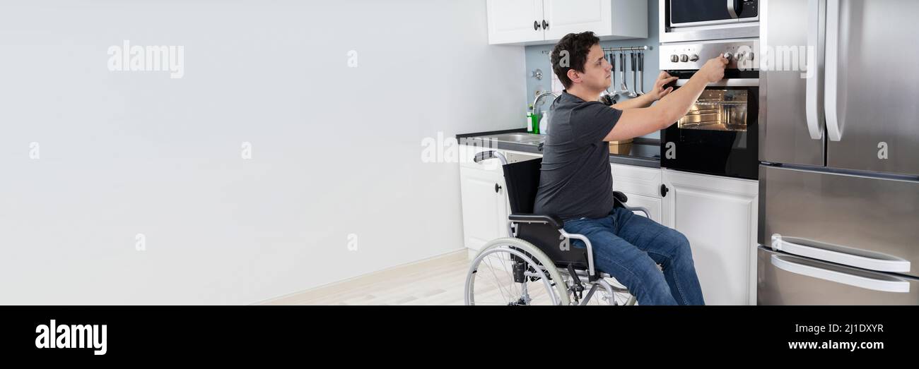 Disabled Man Using Microwave Oven For Baking In Kitchen Stock Photo - Alamy