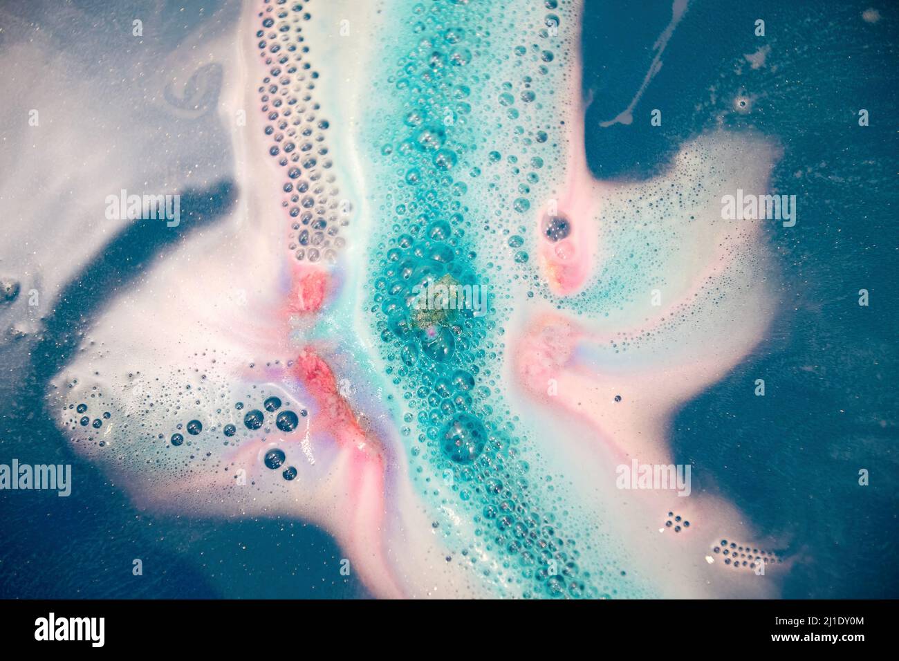 Bright water bomb splash in the bat with blue and pink bubbles and foam ...