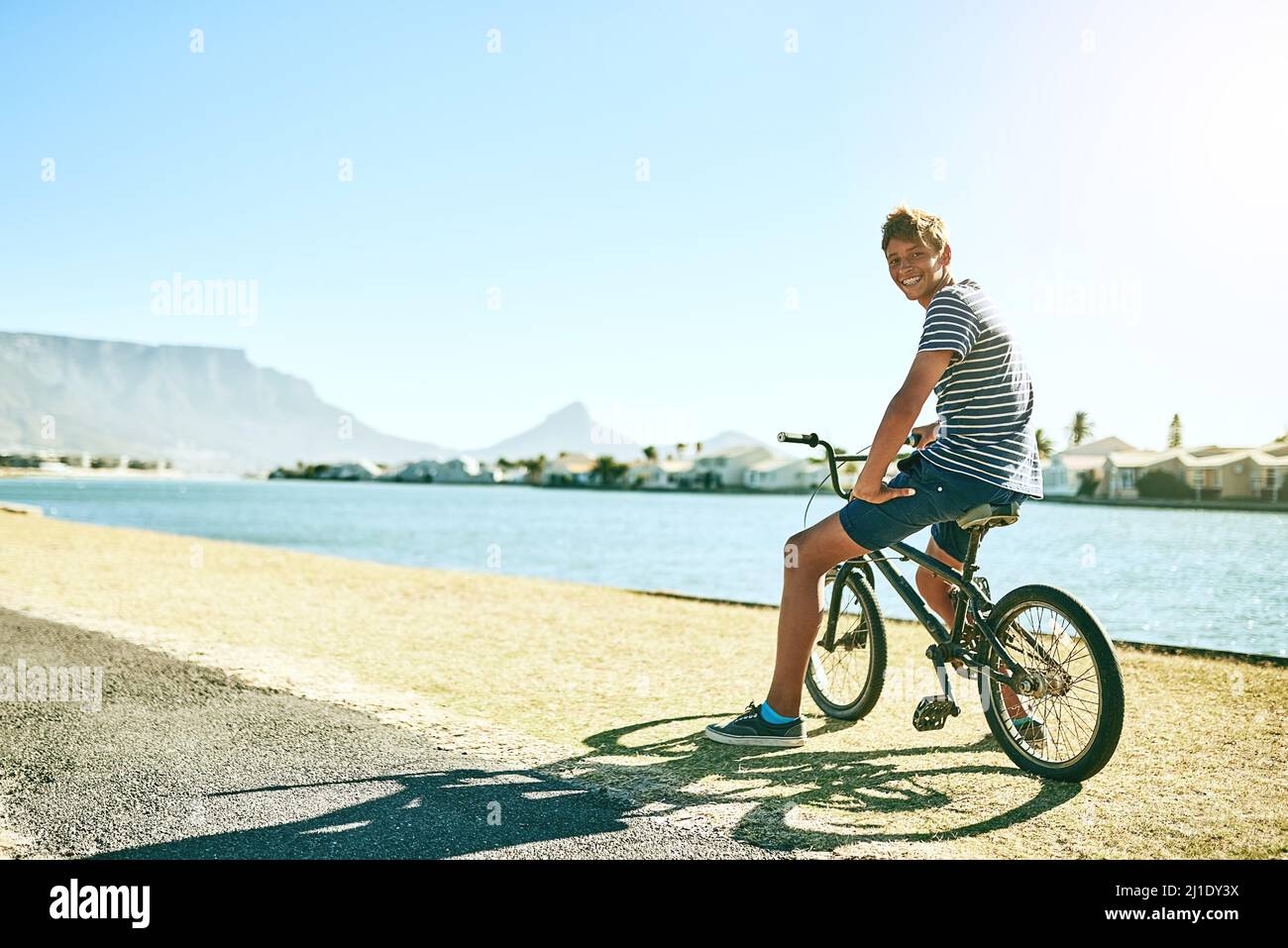 You wanna come for a ride. Full length portrait of a young boy riding ...