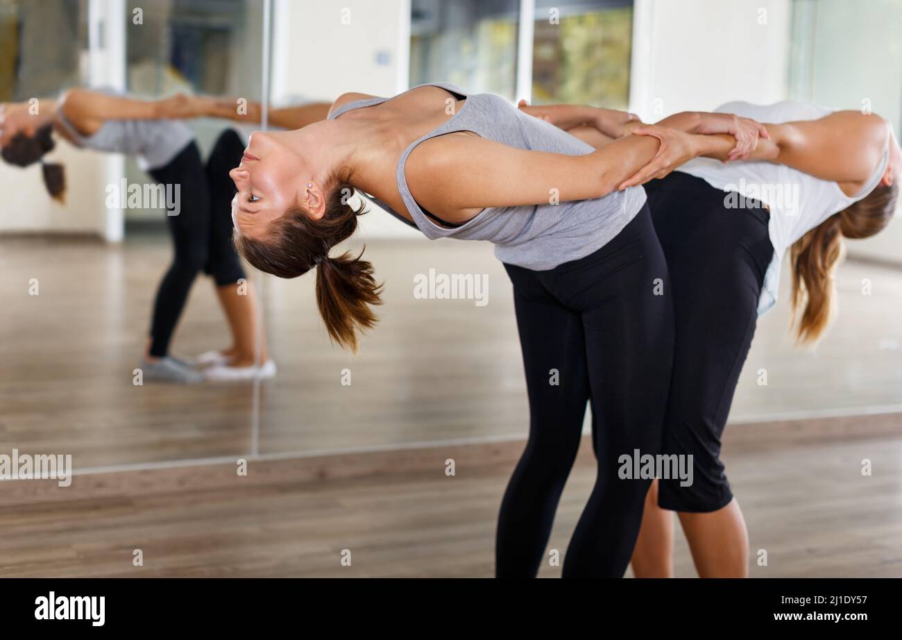 People doing stretching exercises in pairs Stock Photo - Alamy