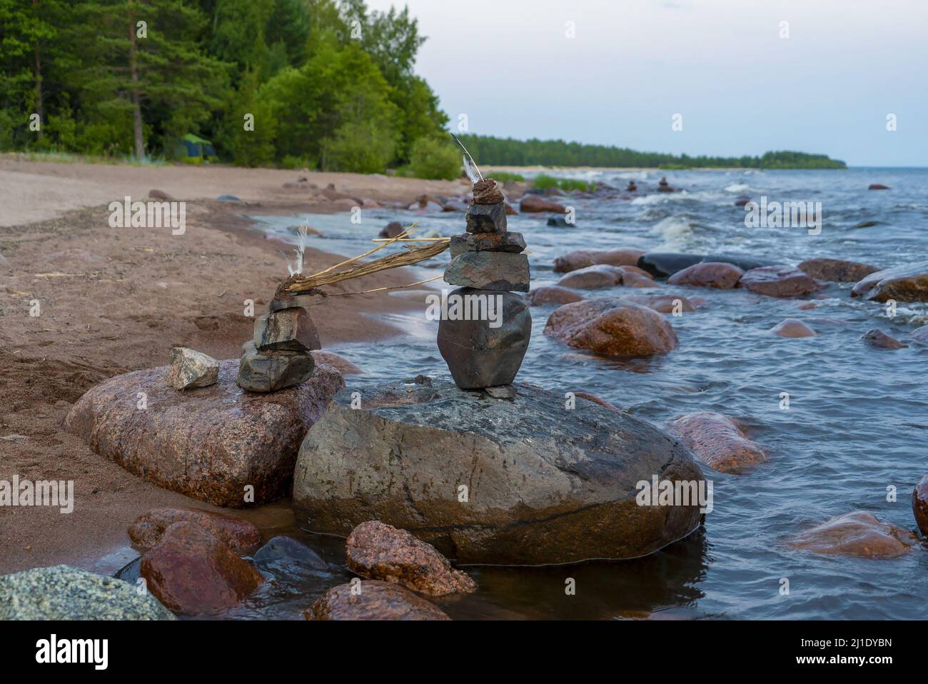 The stones are displayed in pyramids on the shore of the lake Stock ...