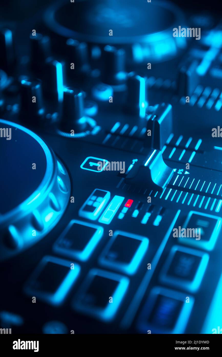 DJ mixing desk turntable in colored wedding disco party lights Stock ...