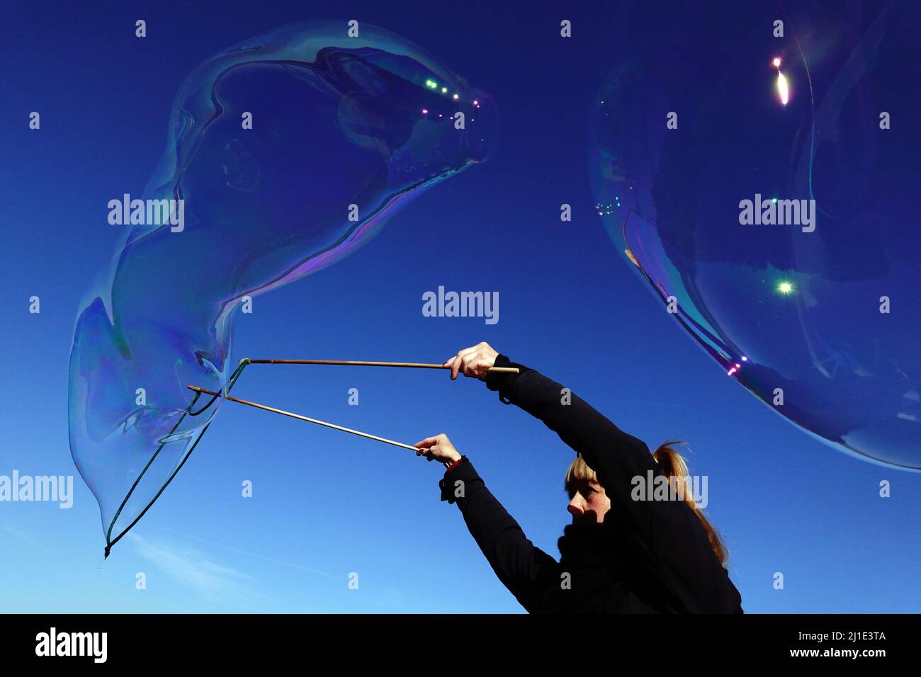 09.10.2021, Germany, Brandenburg, Dranse - Woman making big soap ...