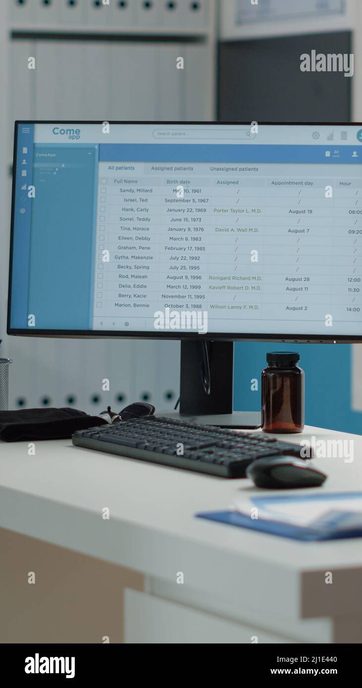 Close up of computer screen with patient information on desk in empty ...