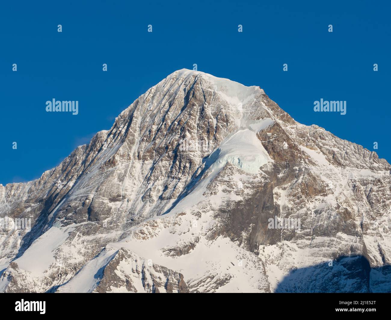 Close-up profile of the famous peak Mönch, Switzerland, with steep rock ...