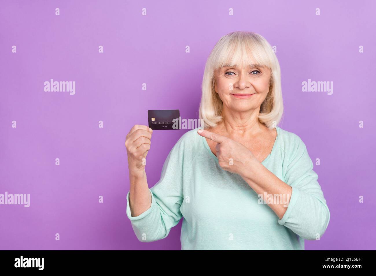 Photo of nice positive old lady direct forefinger debit card wear ...