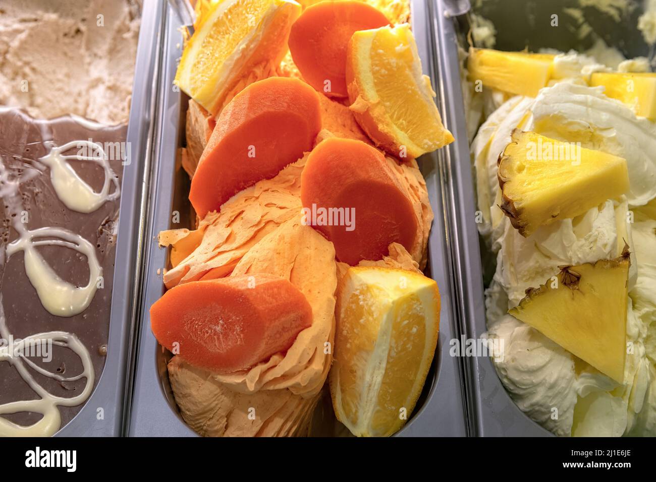 Carrot and orange ice cream. Various ice creams in tray in the ice ...