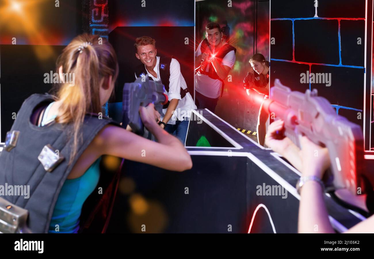 Teams of laser tag game girls and guys playing emotionally oppos Stock ...