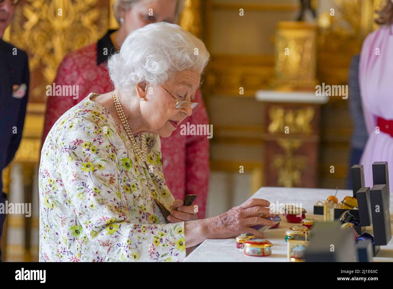 Queen Elizabeth II views a display of artefacts from British craftwork ...