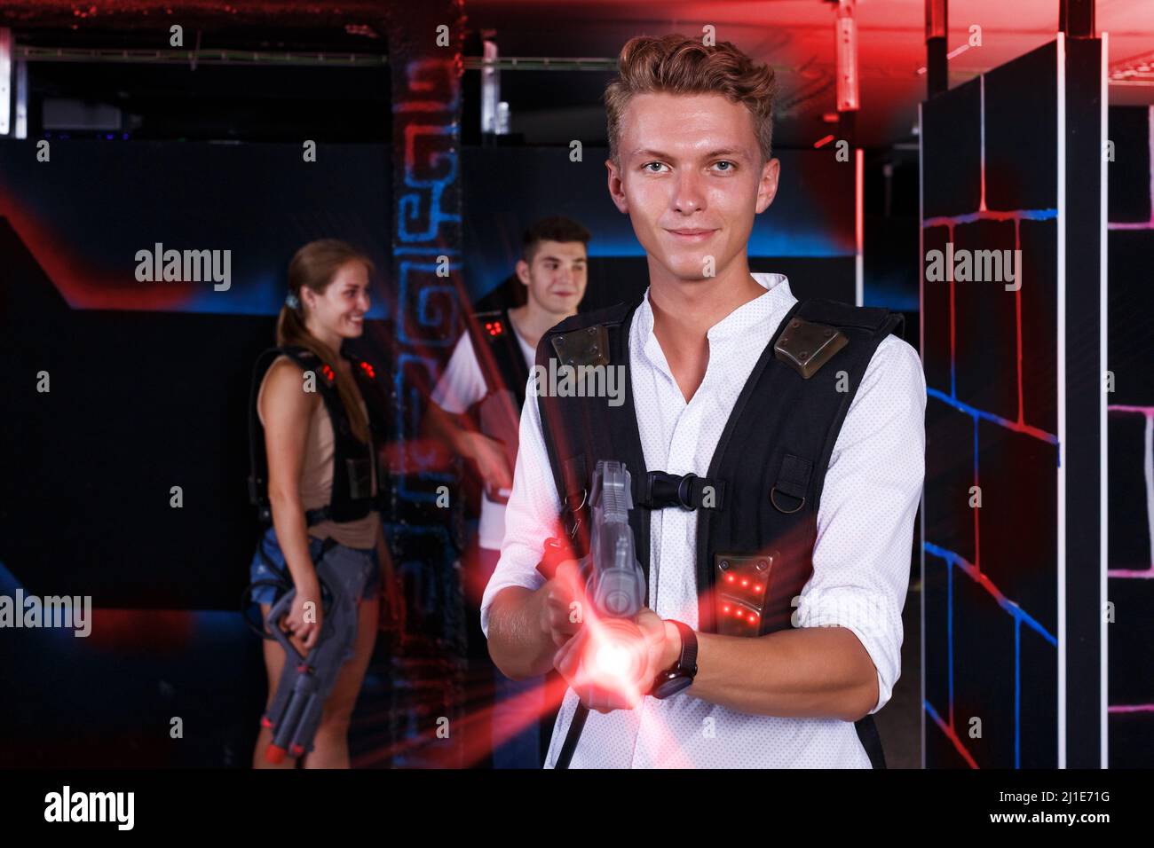 guy holding laser pistol playing laser tag game Stock Photo - Alamy