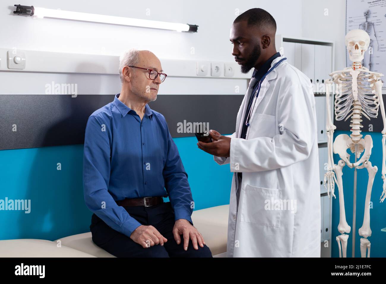 Specialist therapist doctor holding pills bottle explaining medication ... Specialist therapist doctor holding pills bottle explaining medication ...