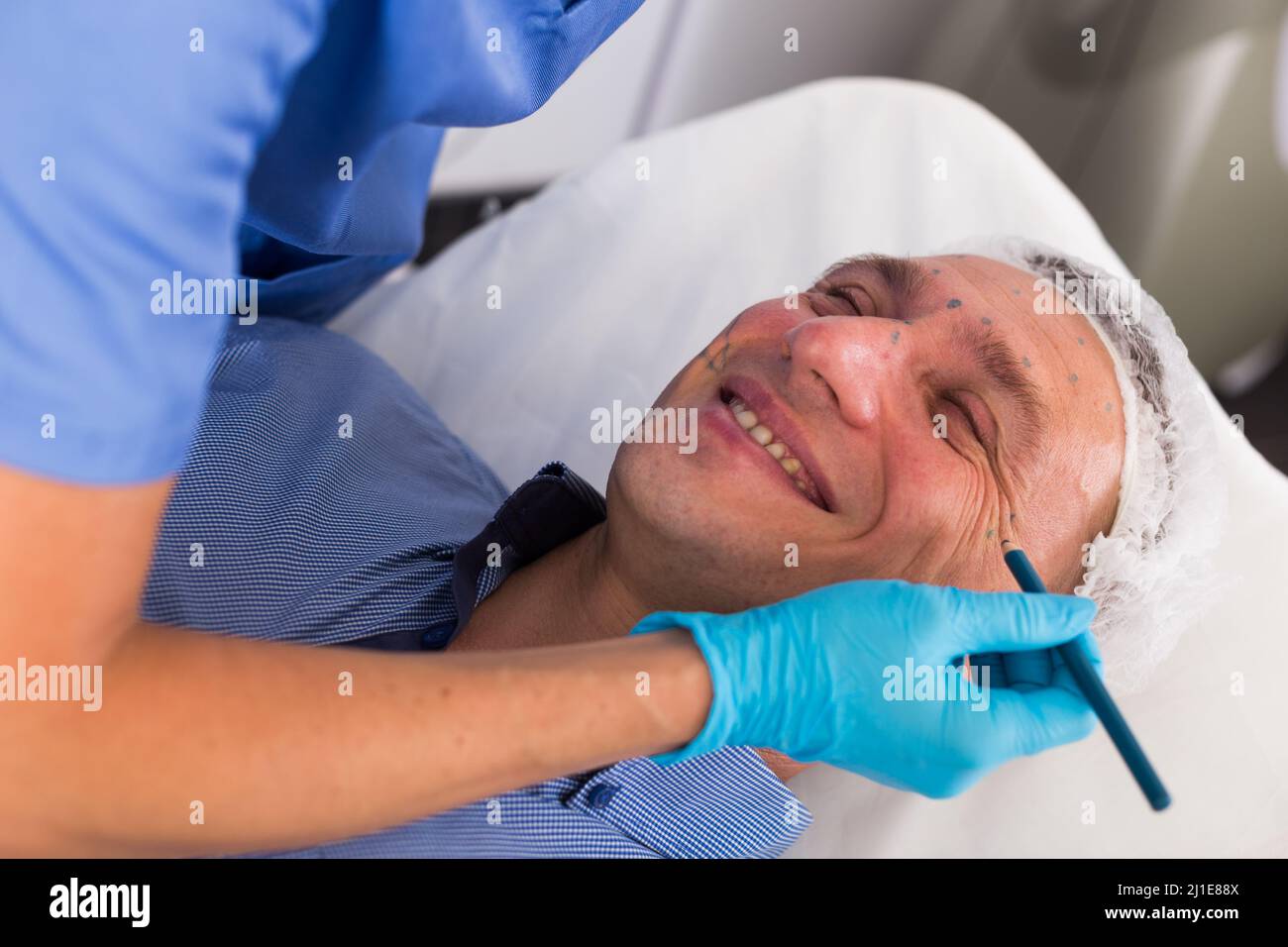 Female doctor is preparing patient for procedure with using marker ...