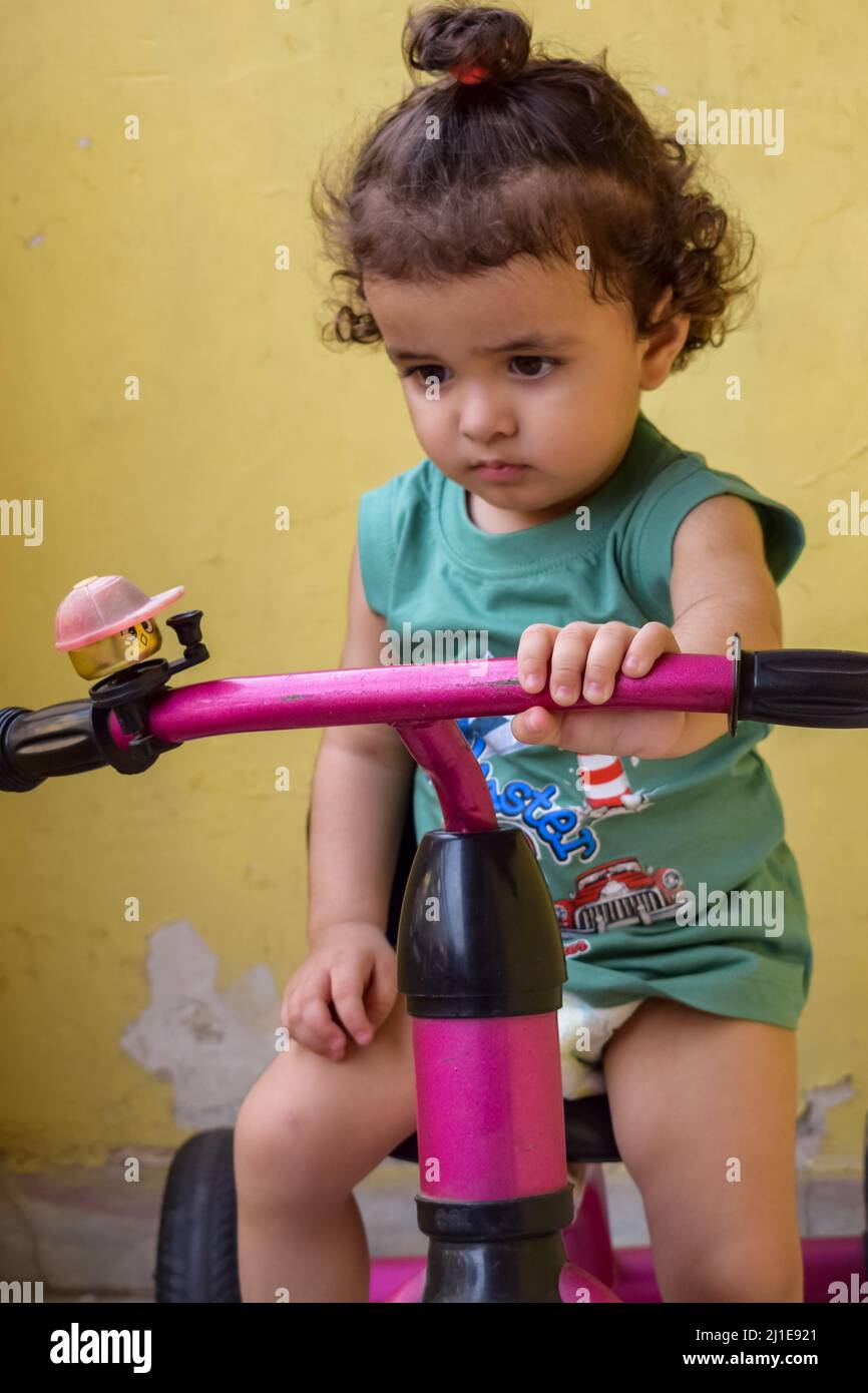 Cute little boy Shivaay driving cycle at home balcony during summer ...