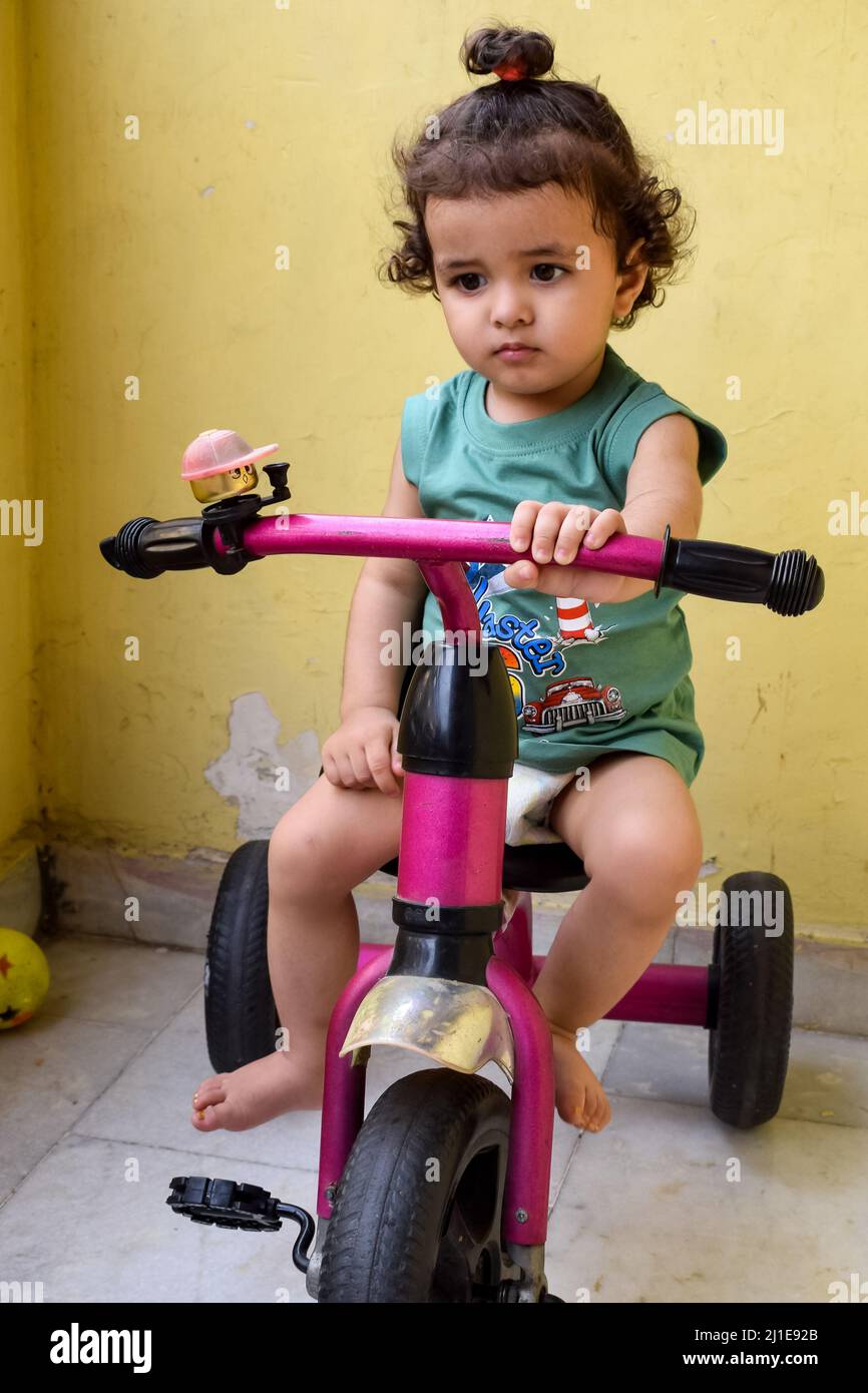 Cute little boy Shivaay driving cycle at home balcony during summer ...