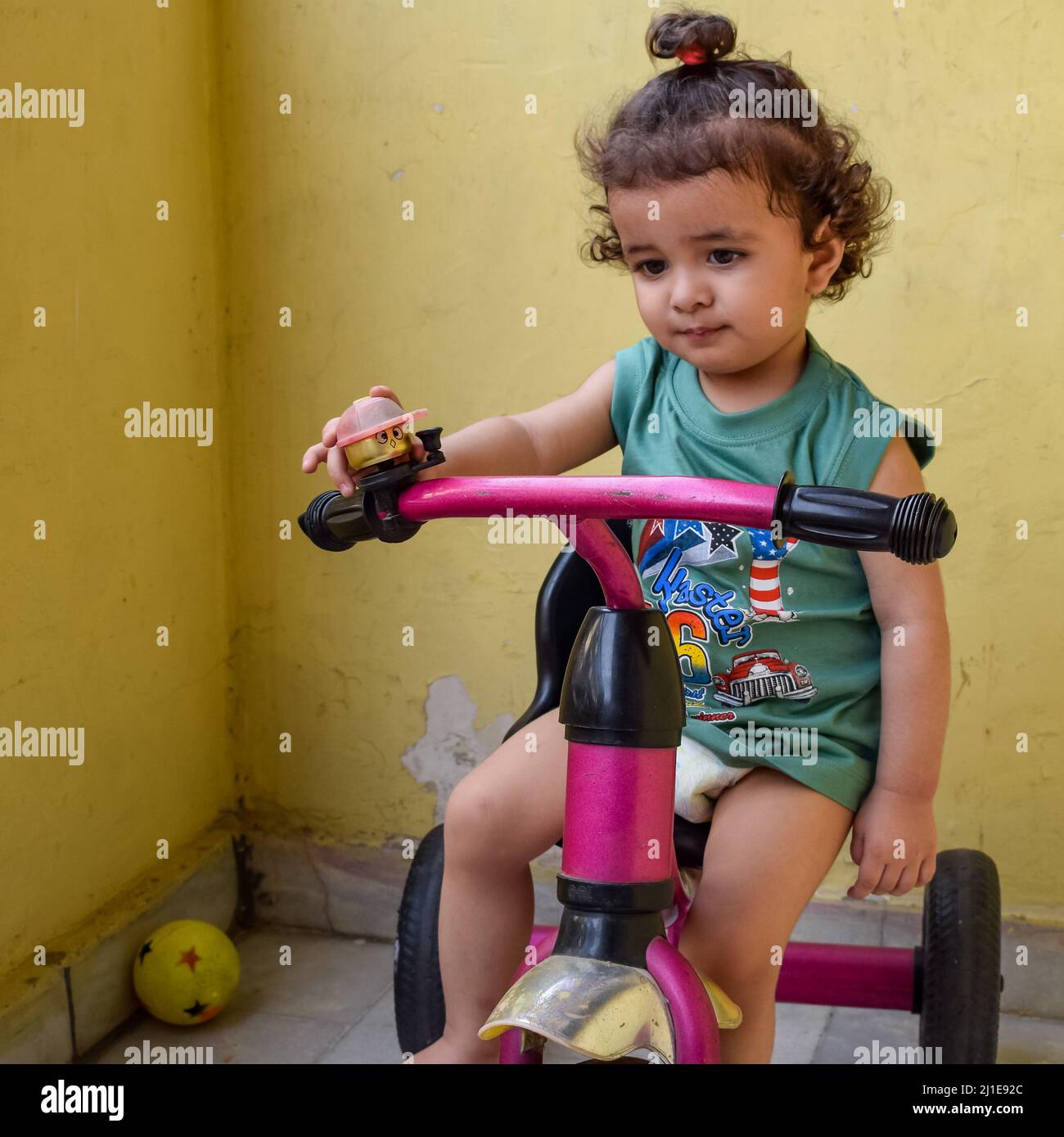 Cute little boy Shivaay driving cycle at home balcony during summer ...