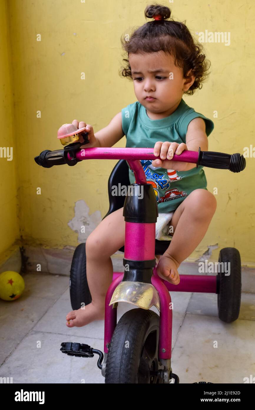 Cute little boy Shivaay driving cycle at home balcony during summer ...
