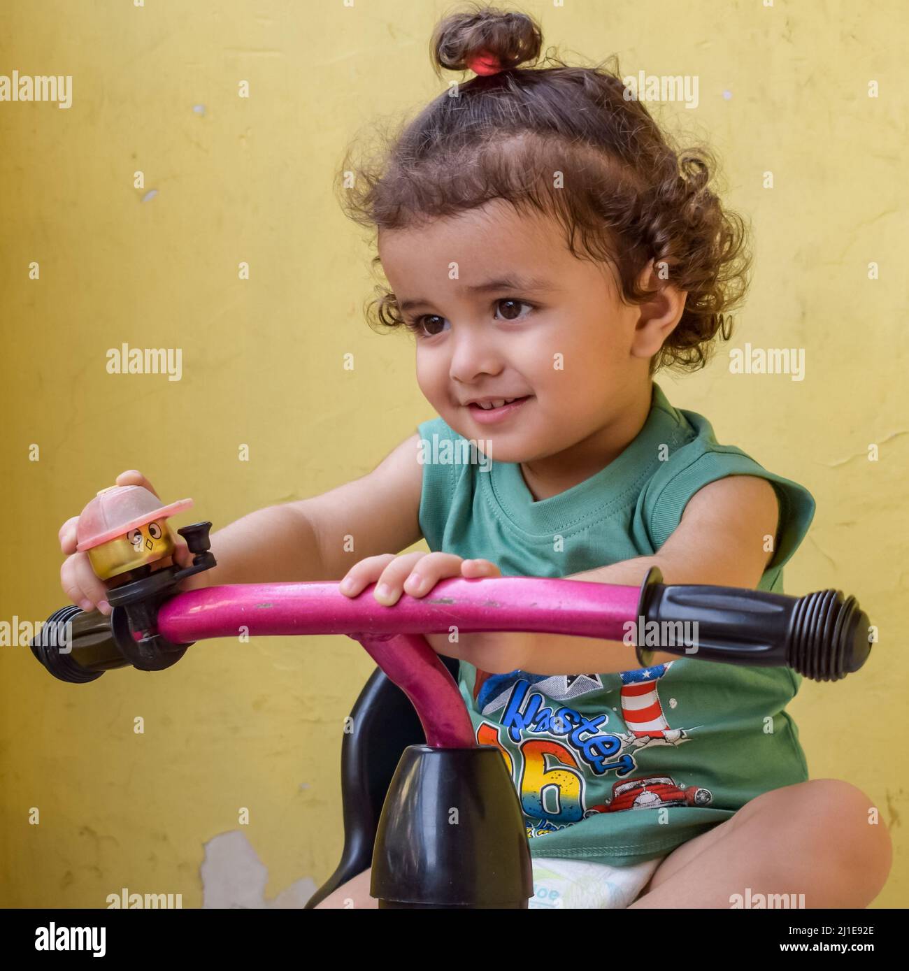 Cute little boy Shivaay driving cycle at home balcony during summer ...
