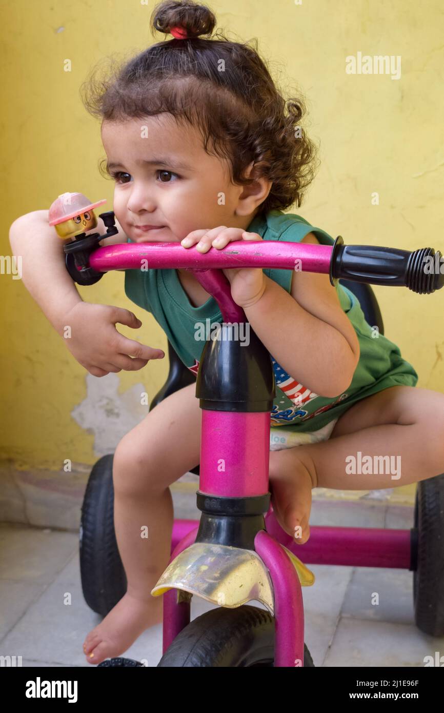 Cute little boy Shivaay driving cycle at home balcony during summer ...