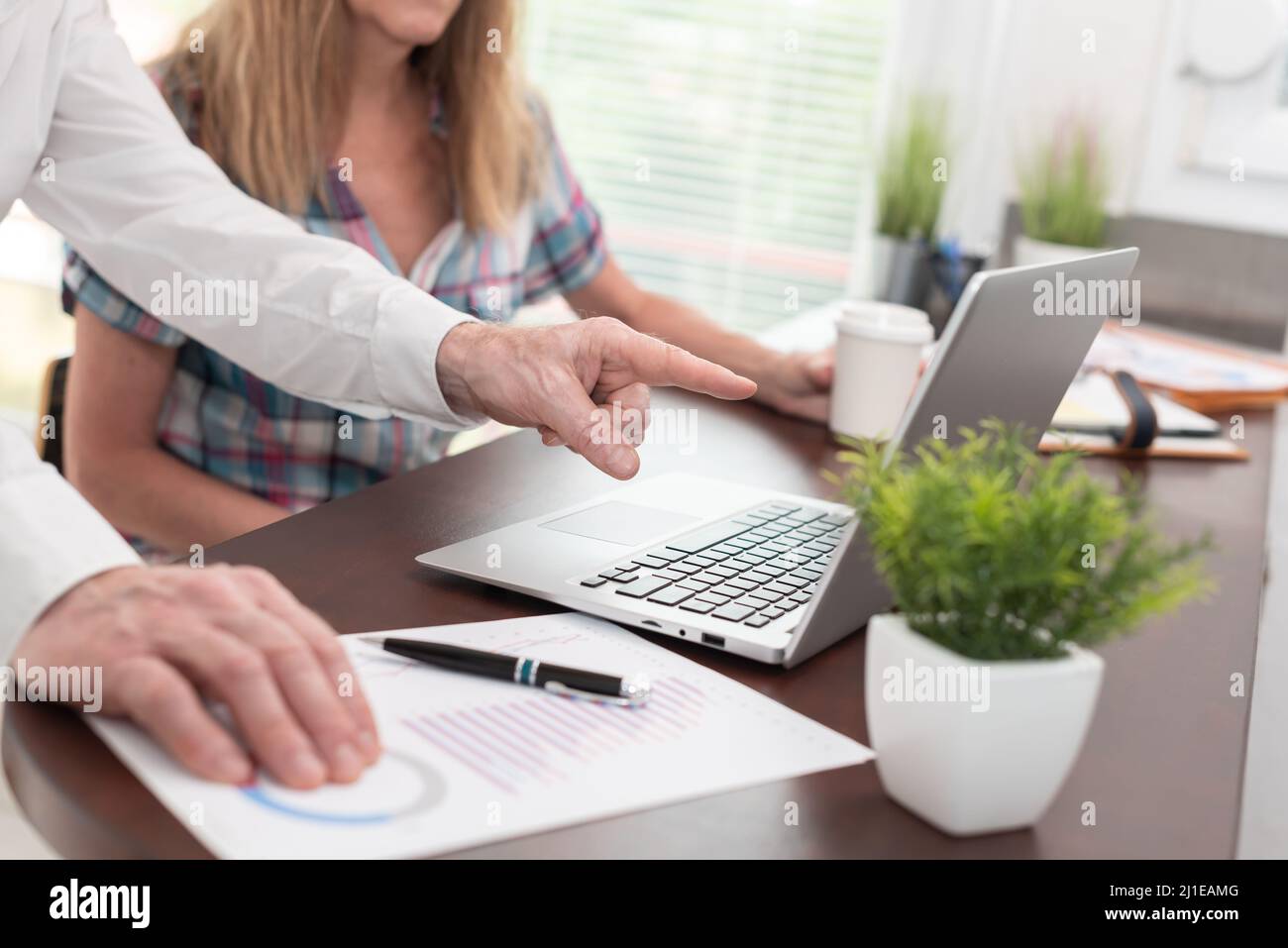 Two business people working together in office Stock Photo - Alamy