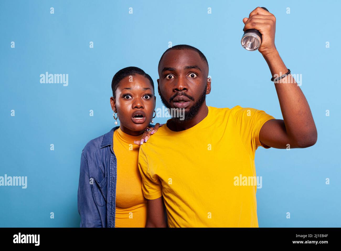 Terrified people using flashlight to check problem source, having ...