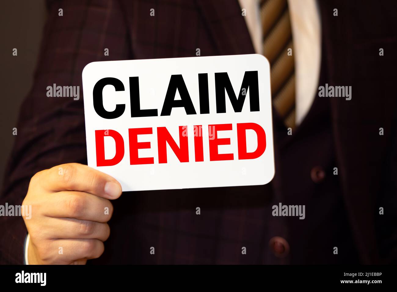 Businessman putting a card with text Claim Denied in the pocket Stock ... Businessman putting a card with text Claim Denied in the pocket Stock ...