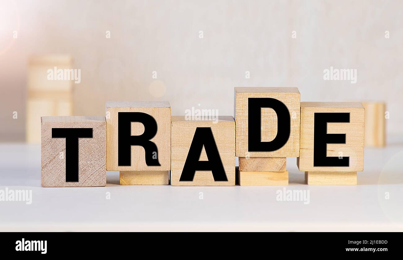 TRADE word written on wood block on a light background Stock Photo - Alamy
