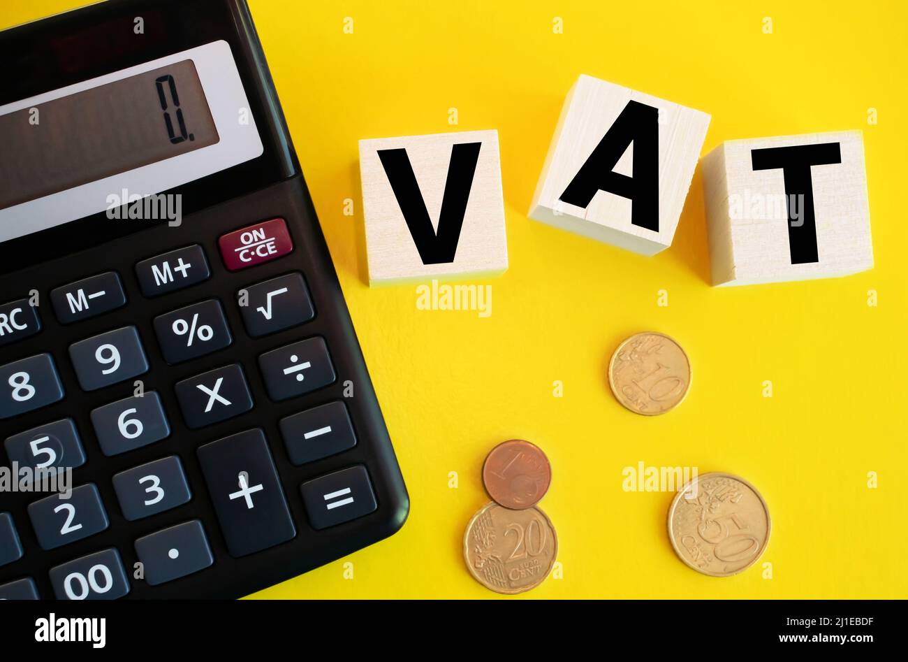 VAT Concept with wooden block with stacked coins Stock Photo - Alamy