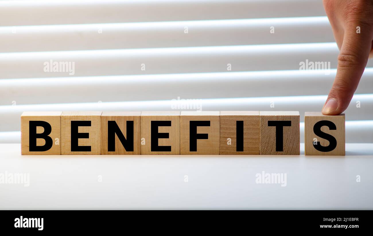 BENEFITS word written on wood block. BENEFITS text on wooden table for ...
