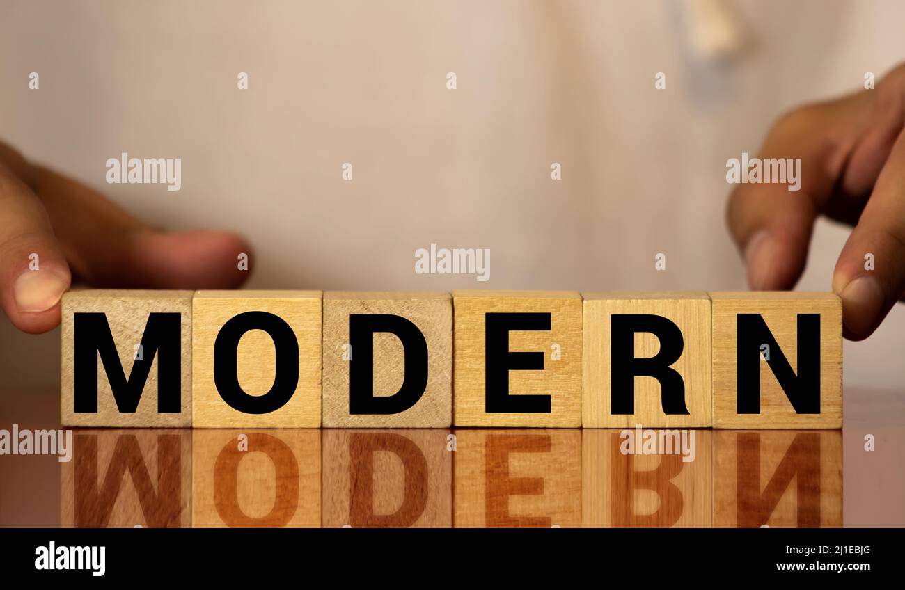 modern word written on wood block. modern text on cement table for your ...