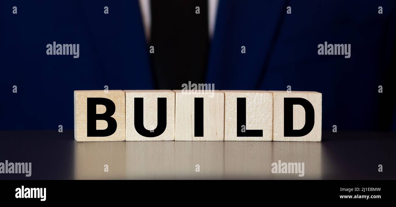 Man made word build with wood blocks Stock Photo - Alamy